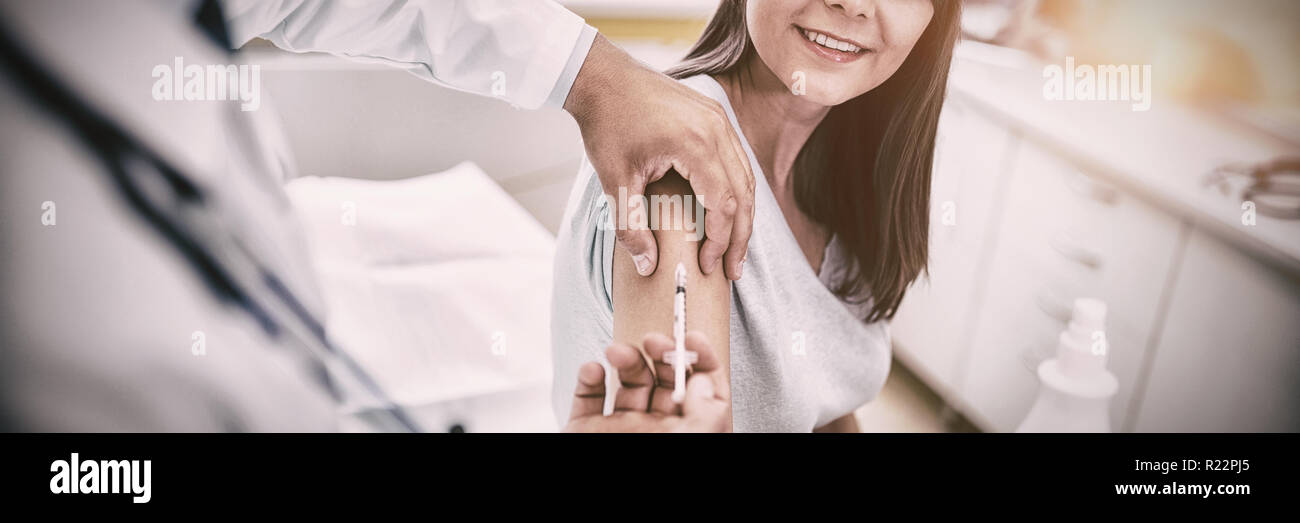 Doctor giving injection male patient hi-res stock photography and ...