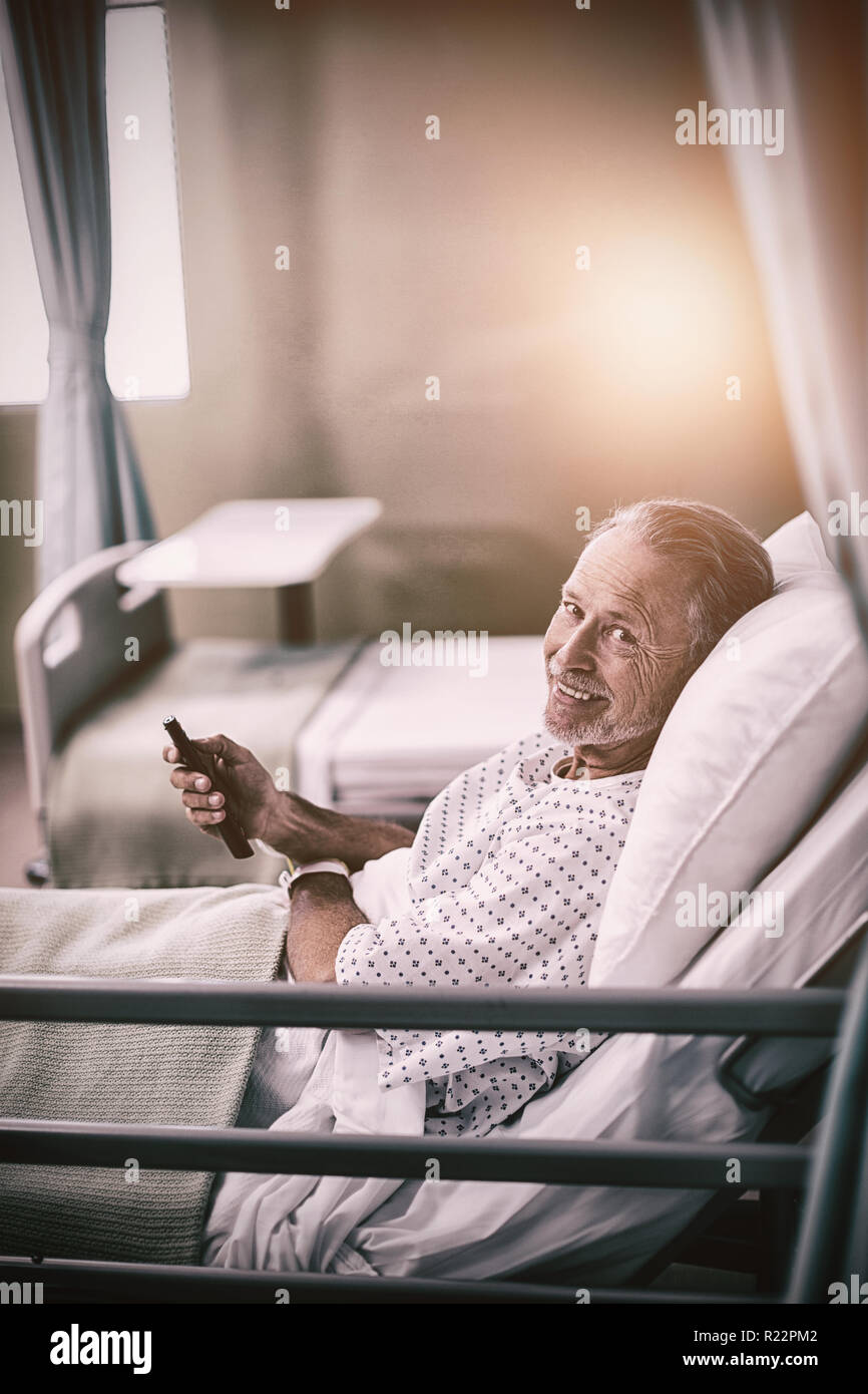 Patient watching television on bed Stock Photo - Alamy