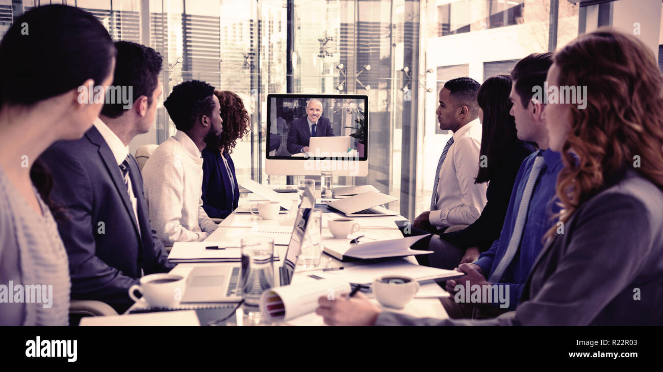 Focused business people looking at screen during video conference Stock ...