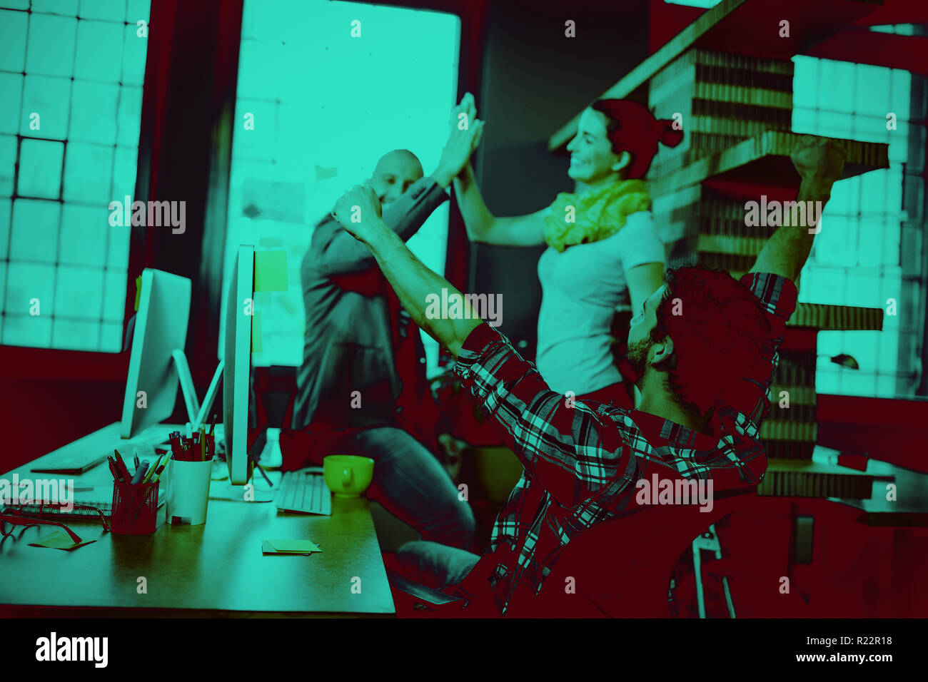 Business people cheering at computer desk Stock Photo - Alamy