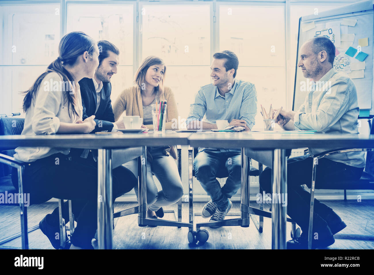 Business people interacting with each other Stock Photo - Alamy
