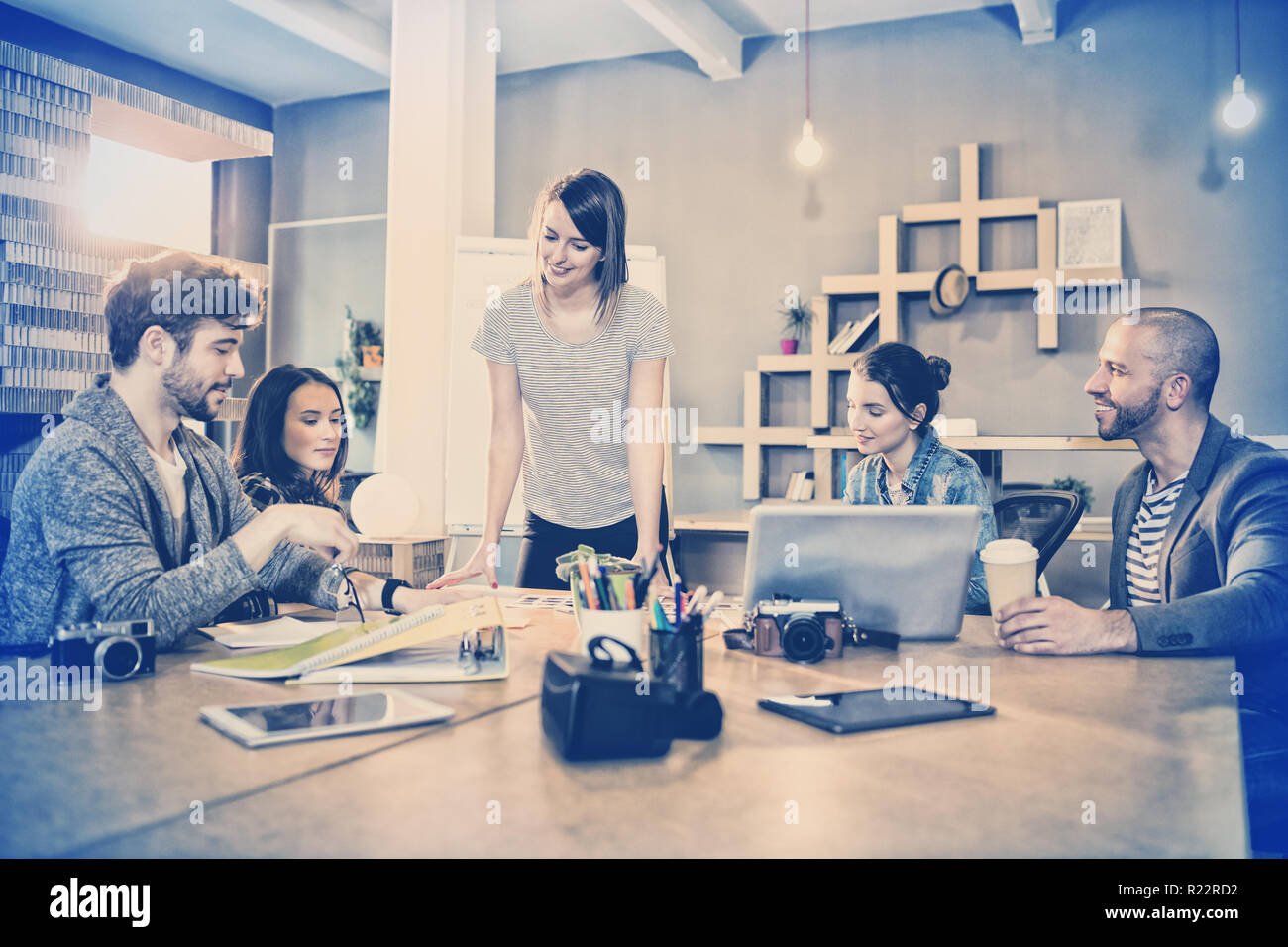 Female graphic designer having discussion with coworkers Stock Photo ...