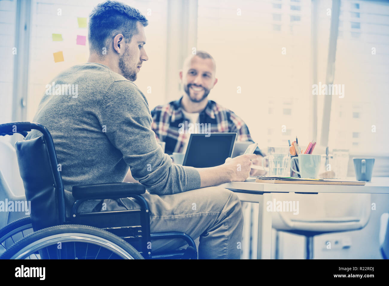 Smiling friends using cell hi-res stock photography and images - Alamy