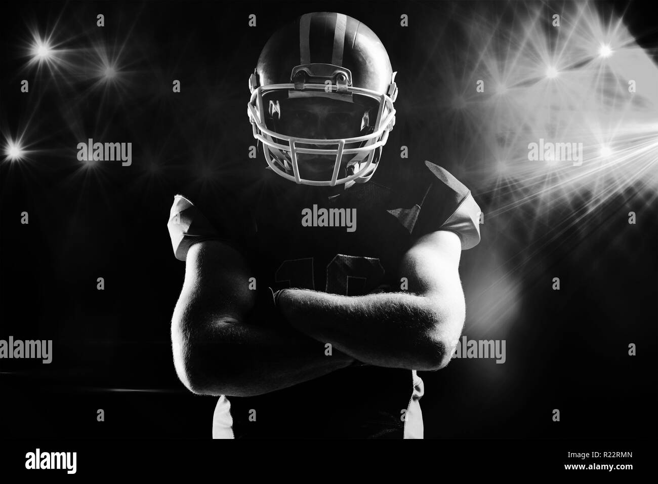 Football player standing arms crossed Black and White Stock Photos ...