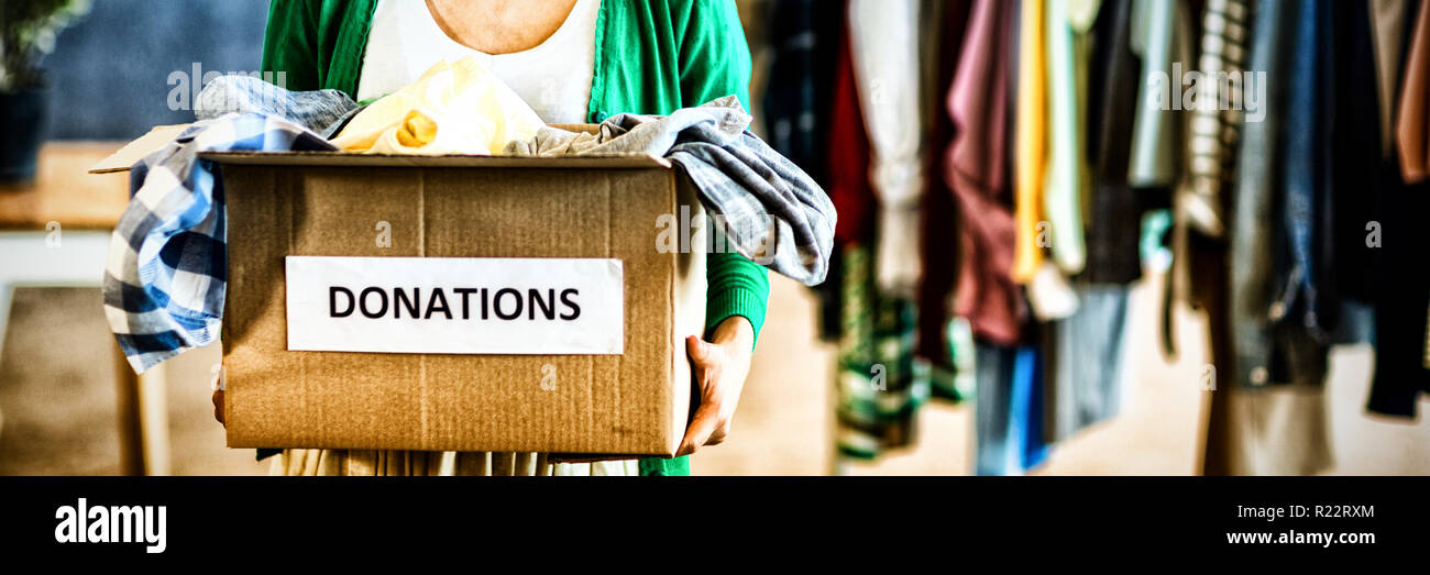 Young woman with donation box Stock Photo - Alamy