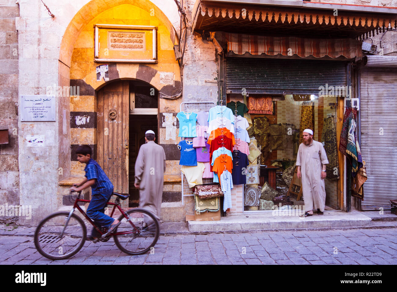 Aleppo, Aleppo Governorate, Syria : A child on a bicycle stands by a ...