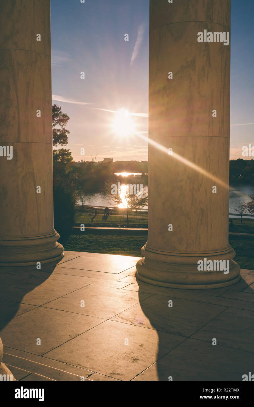 A view of supporting columns with the sun setting in between Stock ...