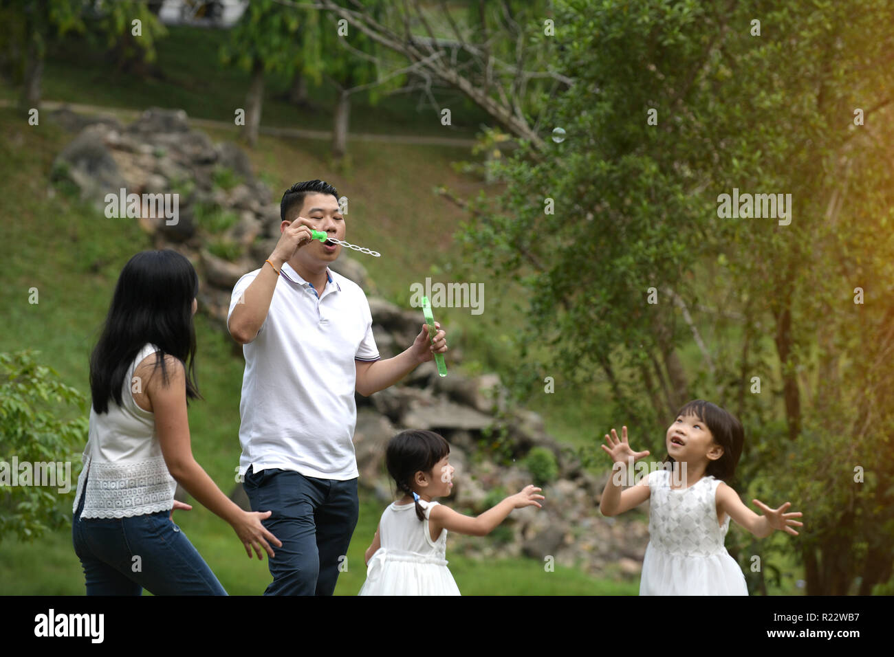 Asian Family Enjoying Walk In Summer Countryside Stock Photo - Alamy