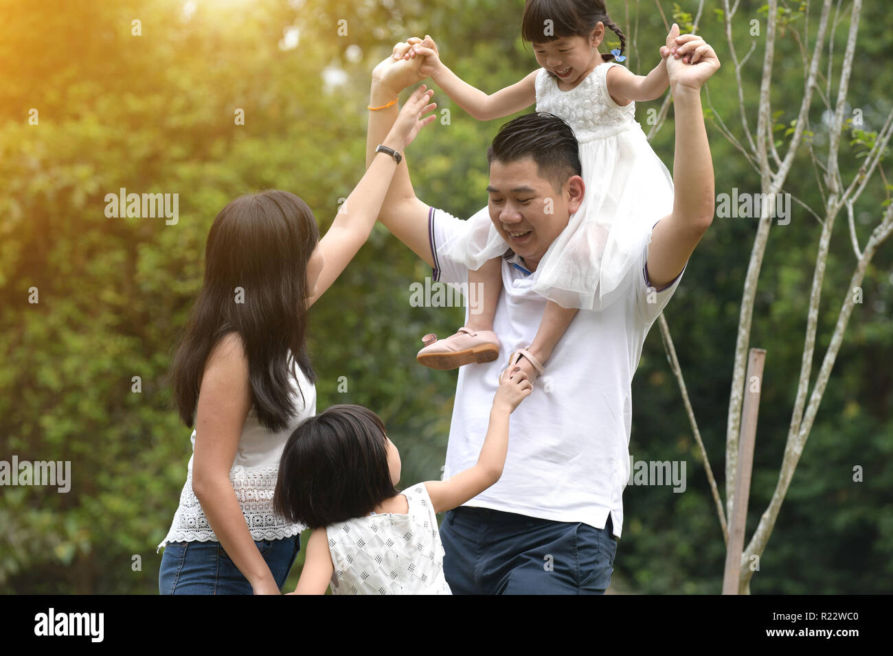 Asian Family Enjoying Walk In Summer Countryside Stock Photo - Alamy