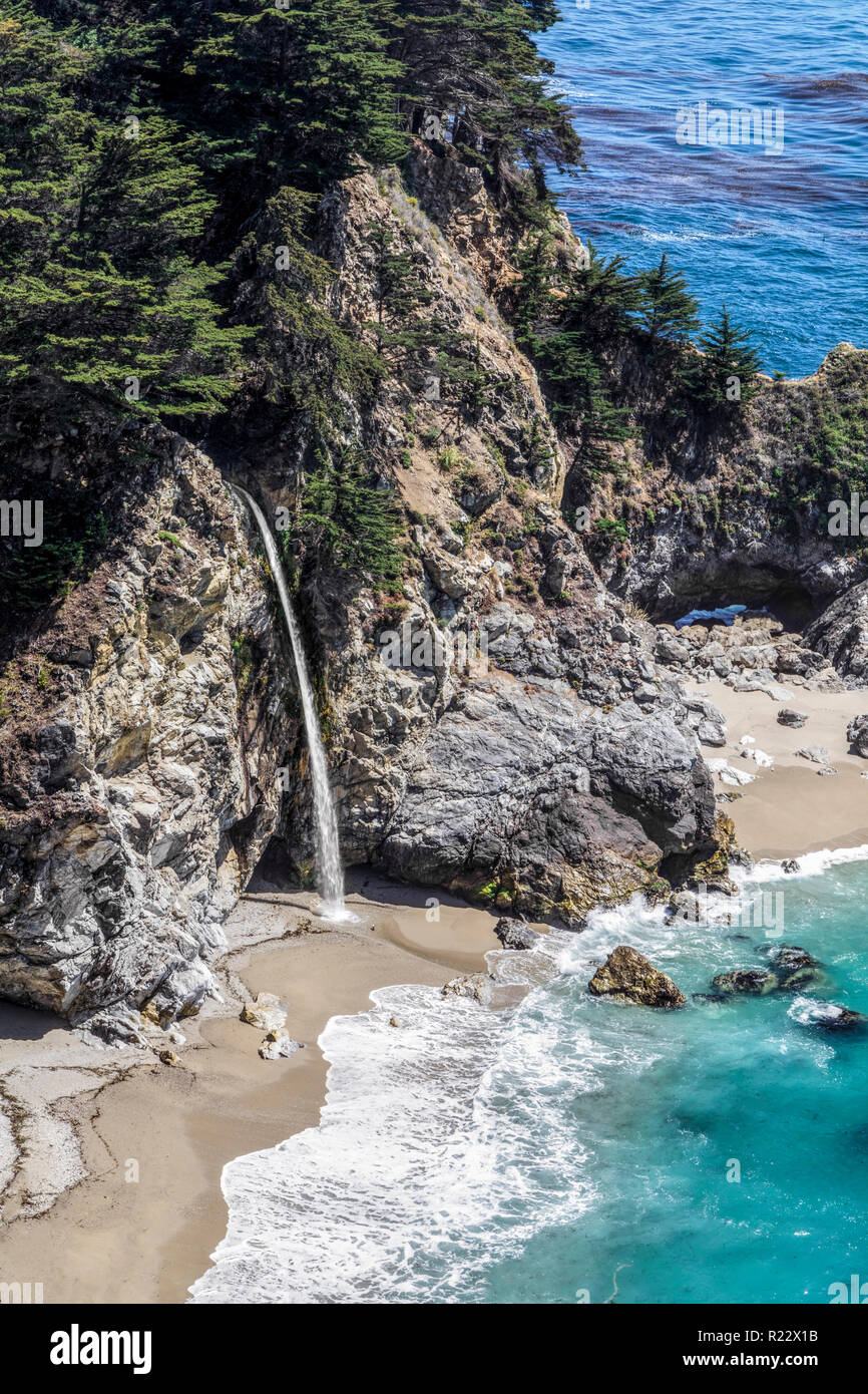 Plunging onto a beach from a rocky cliff along California's Big Sur ...