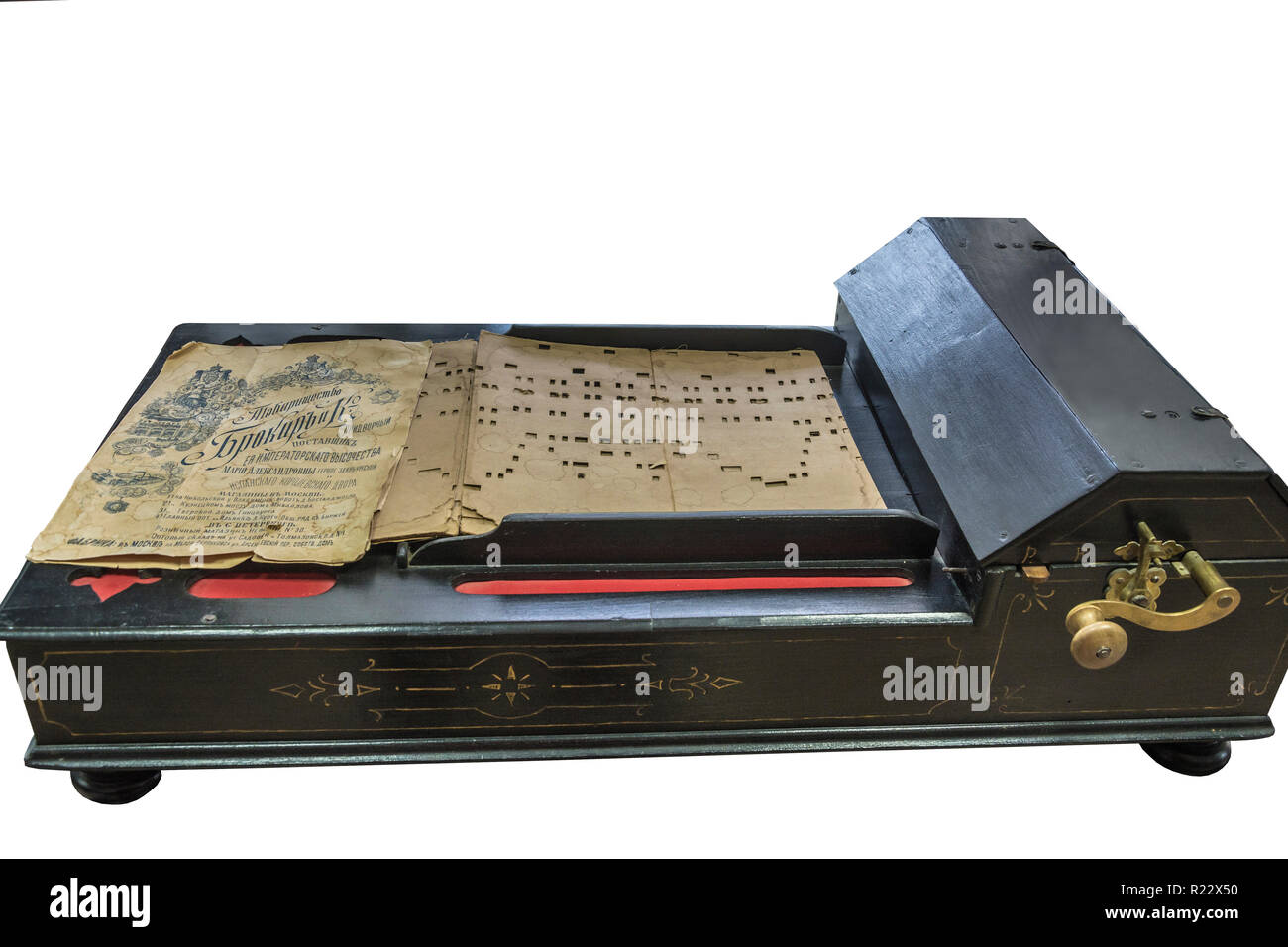 Old-time music box in a black wooden box with perforated tape on a ...