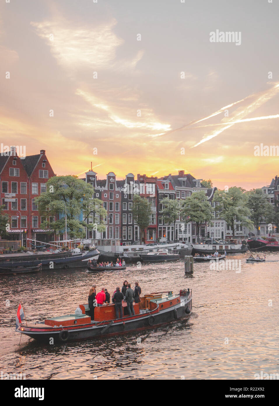 Private small boat riding along the canals of amsterdam with classic ...