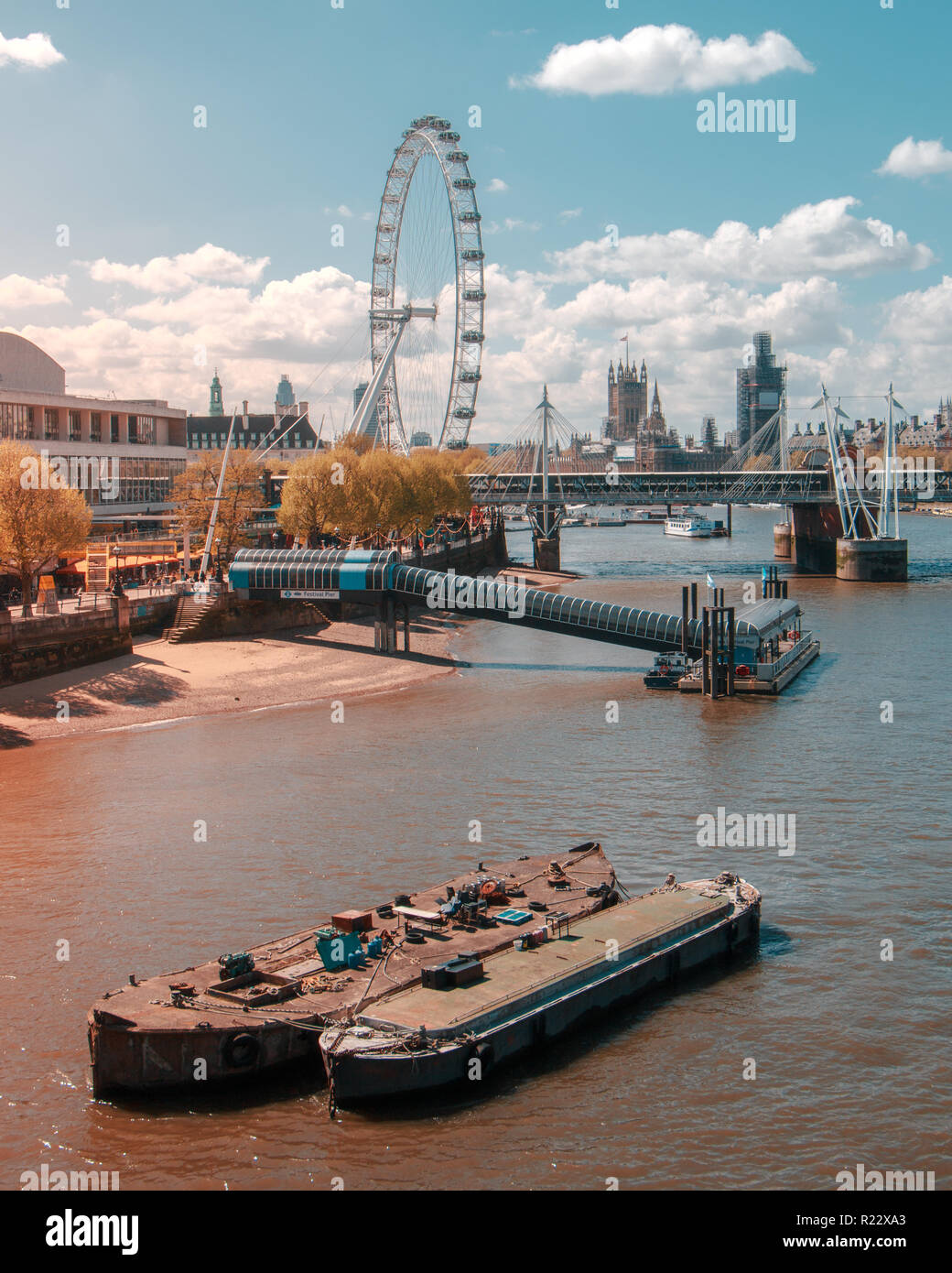 Thames River with barges, docks, london eye, and big ben in the ...