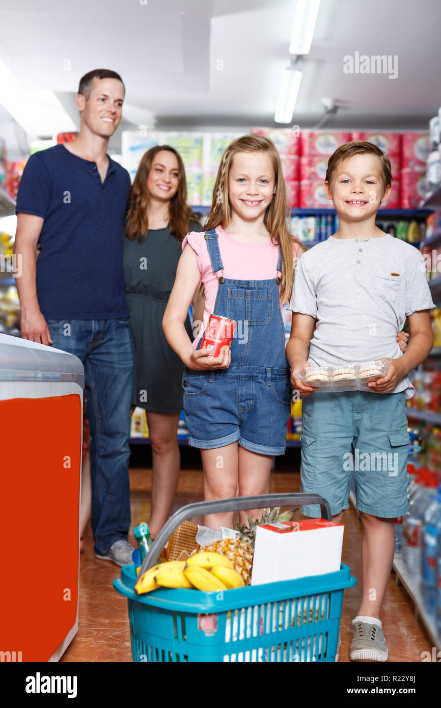 Two kids shopping in the grocery shop hi-res stock photography and ...