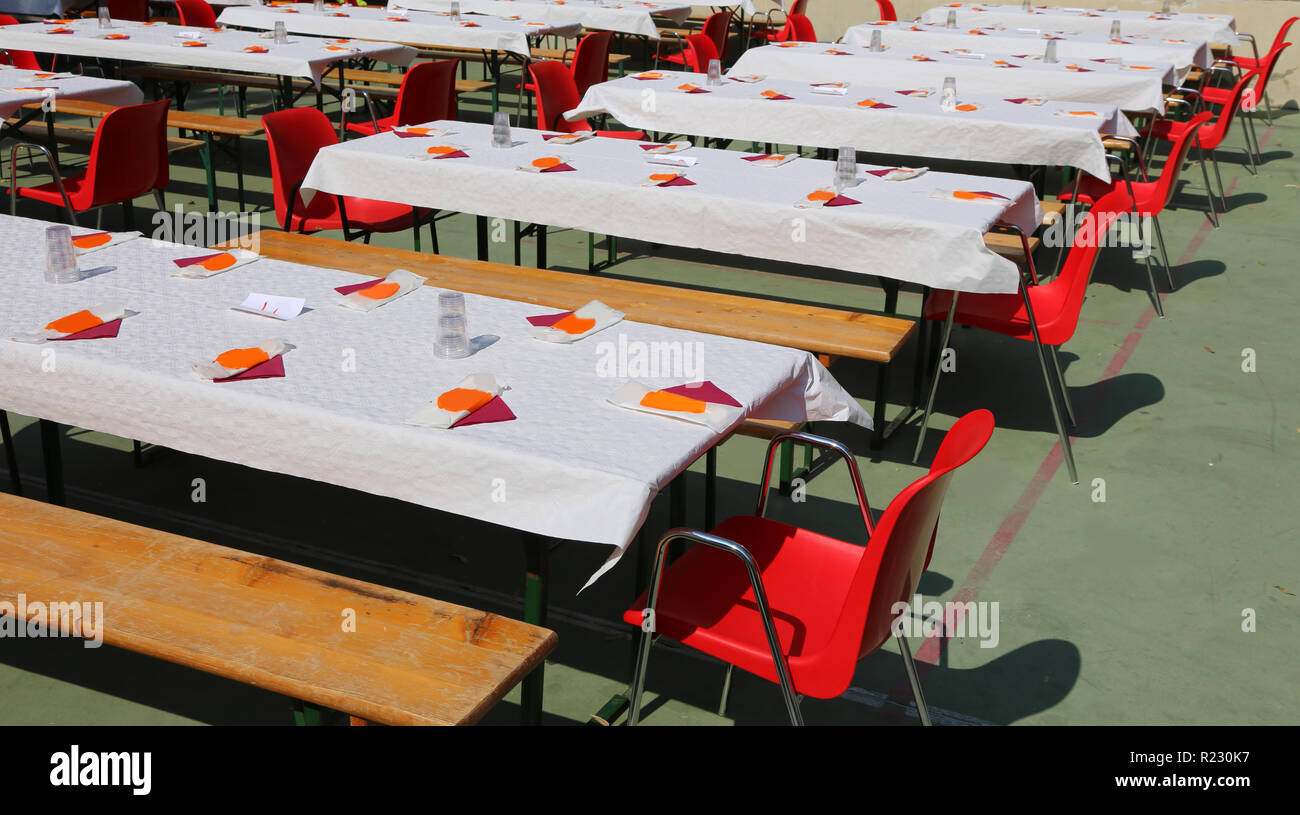 many tables set for a community lunch with many guests Stock Photo - Alamy