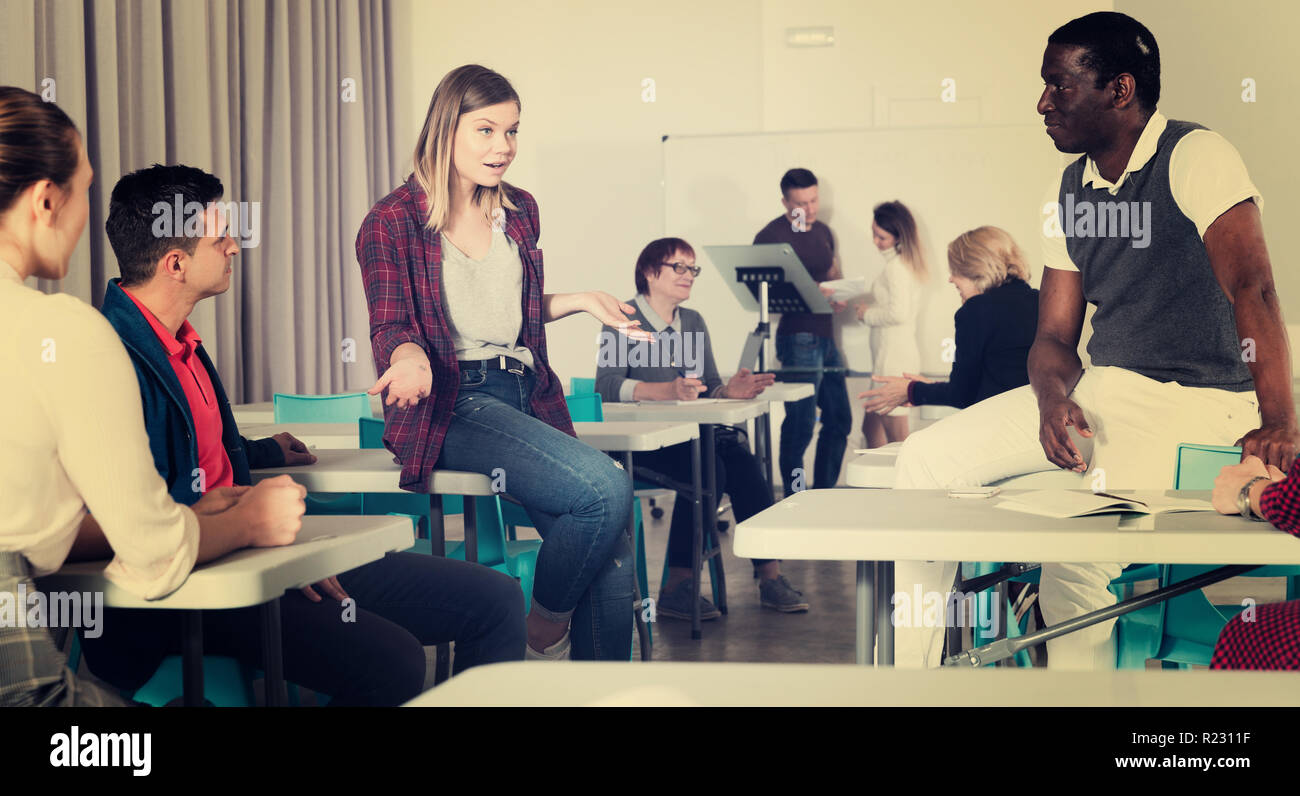 Positive adult students communicating during recess between lectures in ...