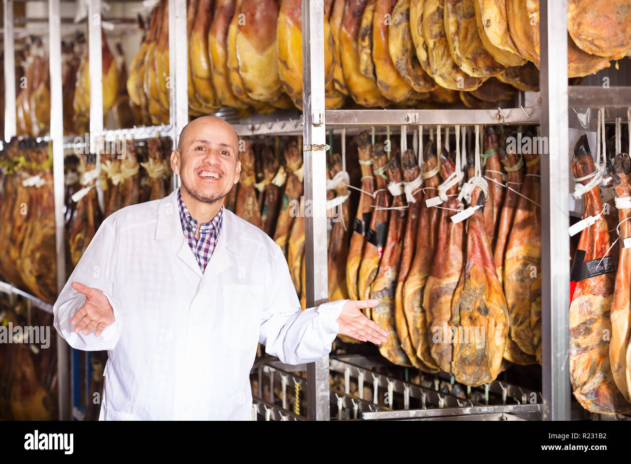 Mature butcher posing with a jamon joints at the meat factory Stock ...