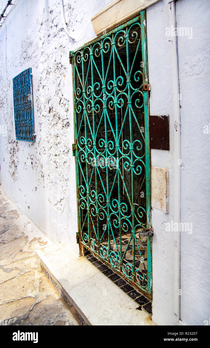 Beautiful ornamental windows on white wall typical for Tunisia ...