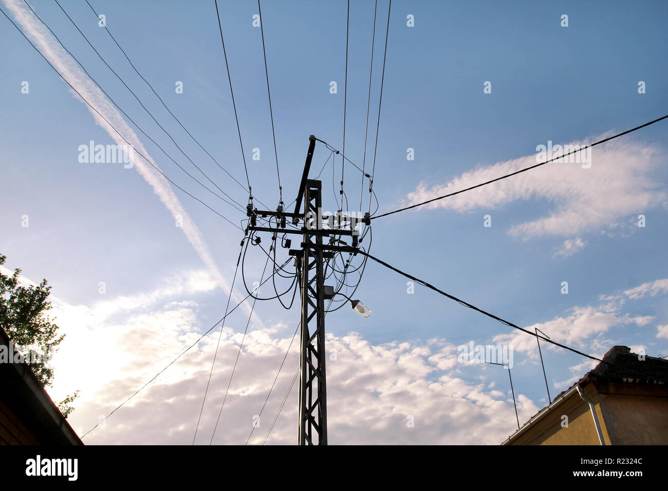 Old Power line electrical wire pillar with street feline lights against ...