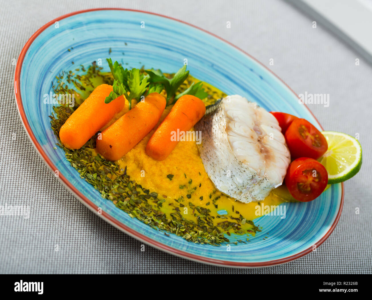 Steamed merluccius served with vegetable pate. Recipe: carrots, onion ...