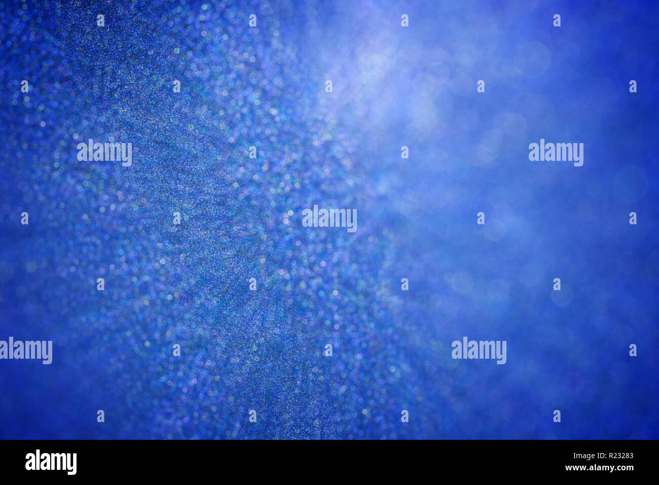 Full frame abstract background of shiny blue glitter, shallow depth of ...