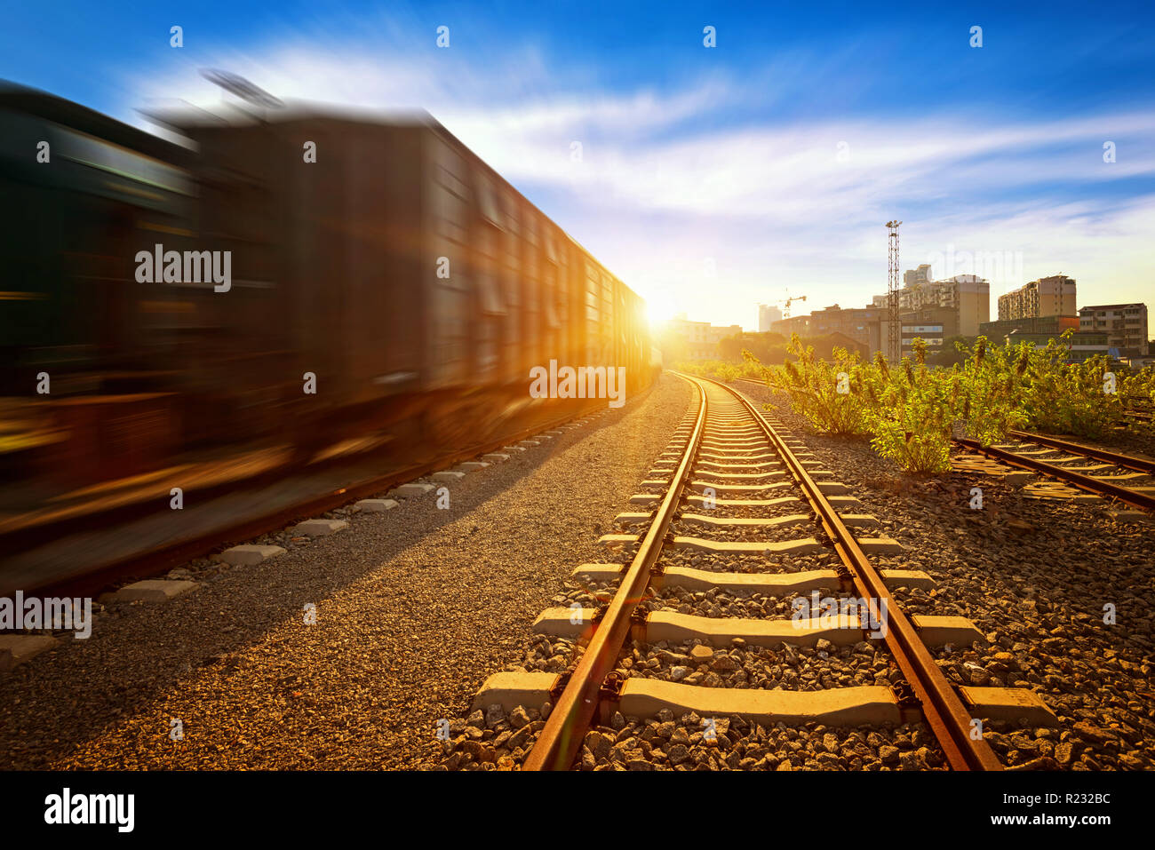 Cargo train platform at sunset with container Stock Photo - Alamy