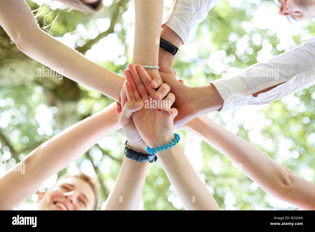 Teenagers joined their hands in a circle Stock Photo - Alamy