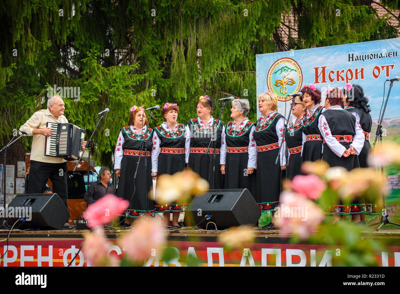 Group of women in traditional Bulgarian folk costumes - singing a song ...