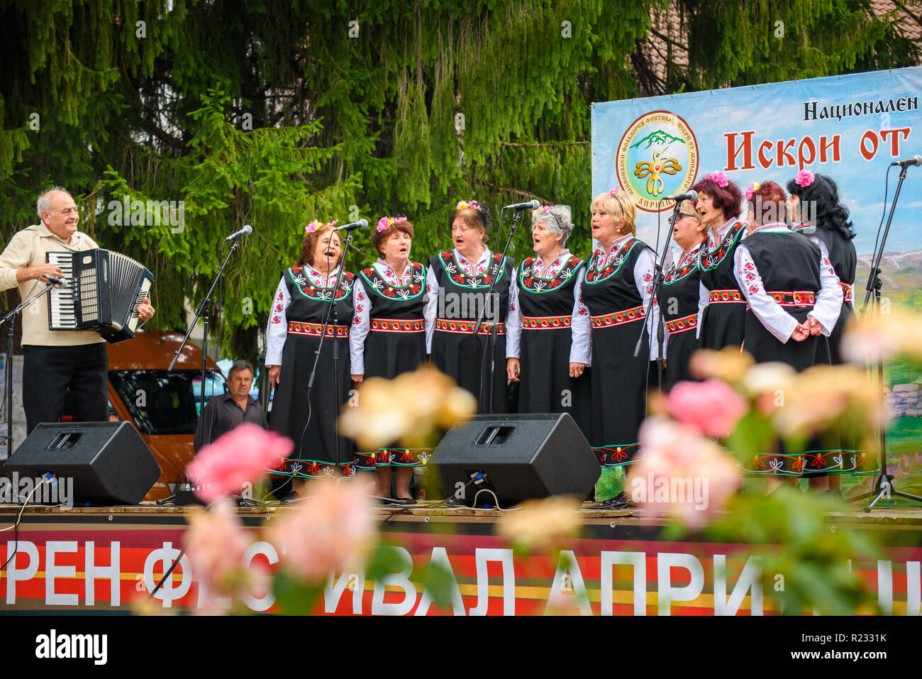 Group of women in traditional Bulgarian folk costumes - singing a song ...