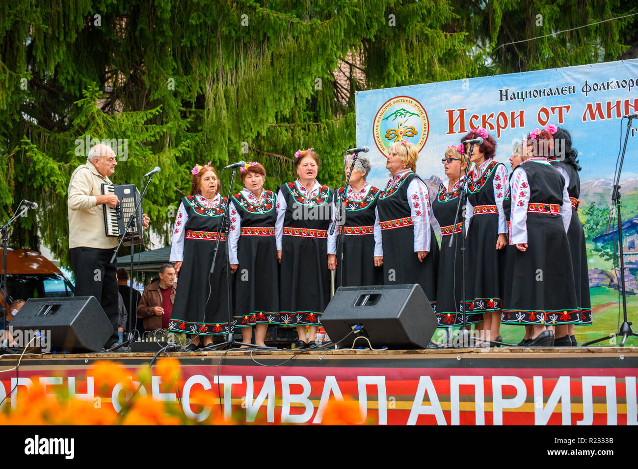 Group of women in traditional Bulgarian folk costumes - singing a song ...