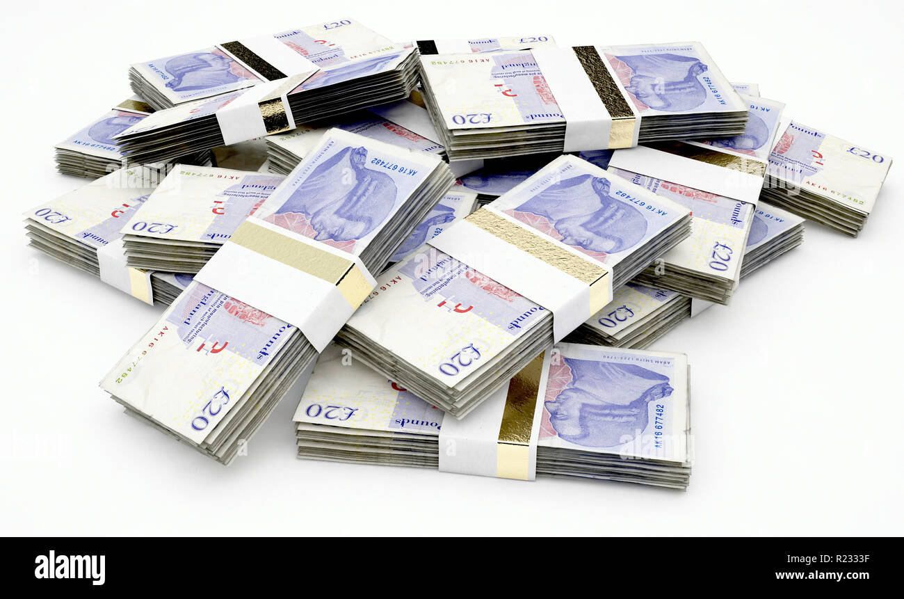 A pile of randomly scattered bundles of british pound banknotes on an ...