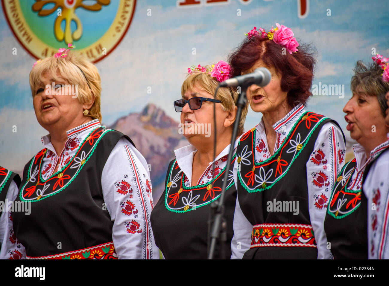 Group of women in traditional Bulgarian folk costumes - singing a song ...