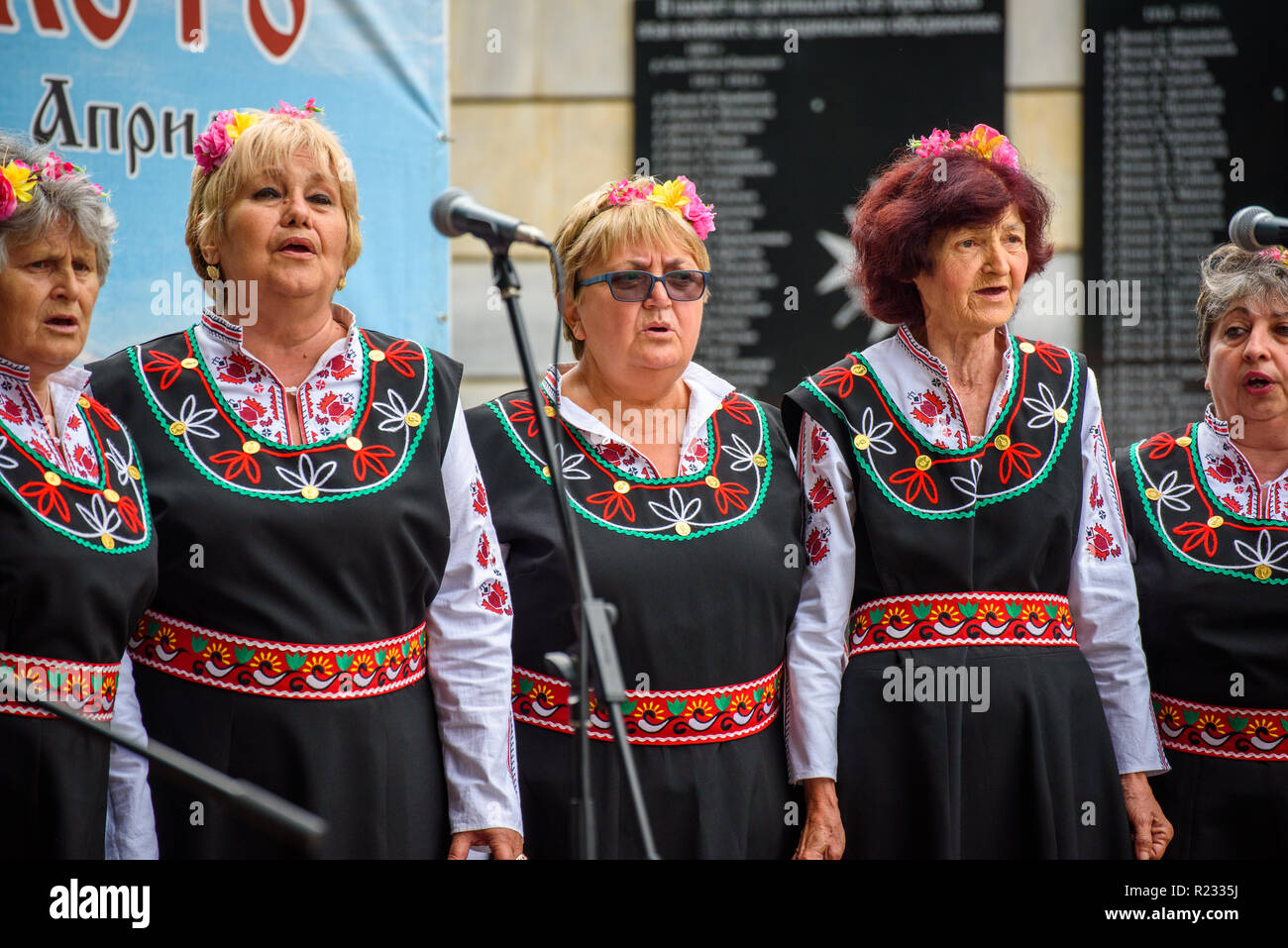 Group of women in traditional Bulgarian folk costumes - singing a song ...