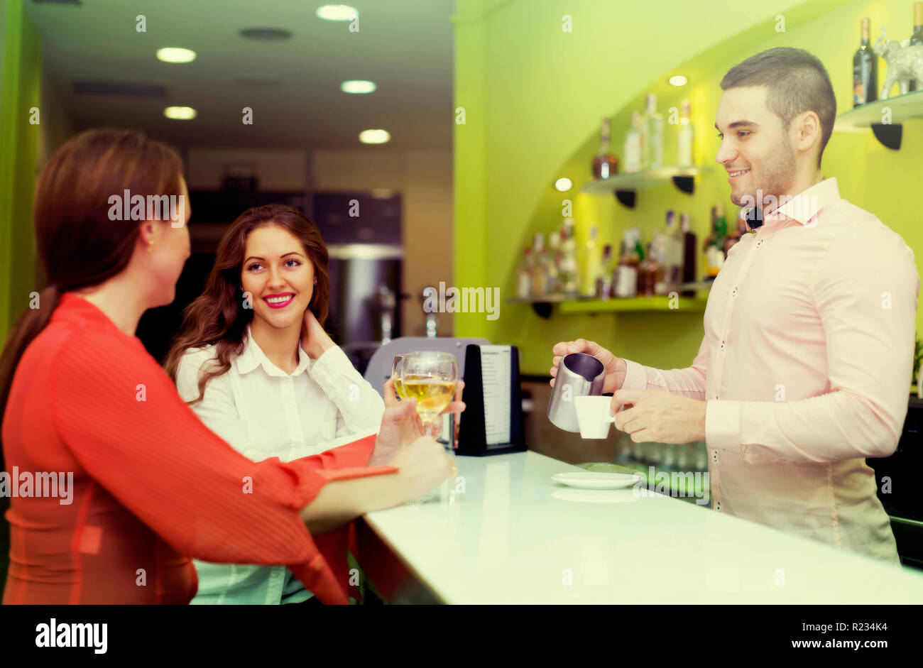 Two beautiful girls flirting handsome hi-res stock photography and ...