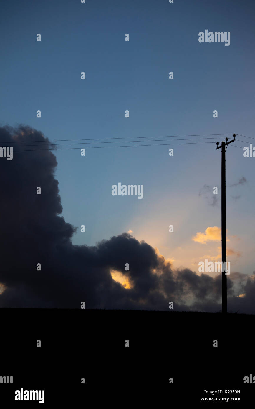 Dusk over farmland in the rural county of Hampshire with tree lined ...