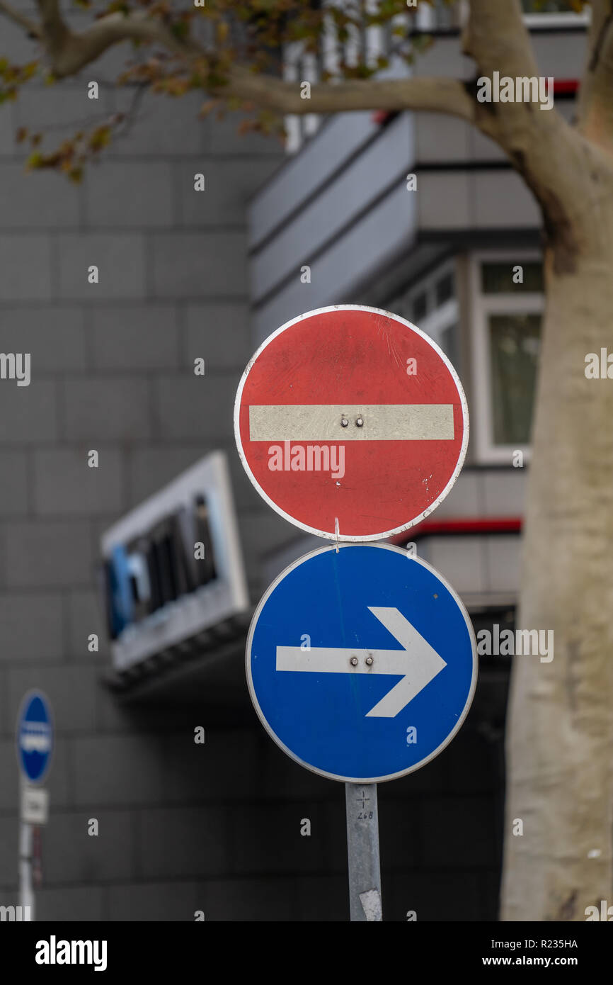 A Traffic Sign don't drive this way and and a blue Sign with a white ...