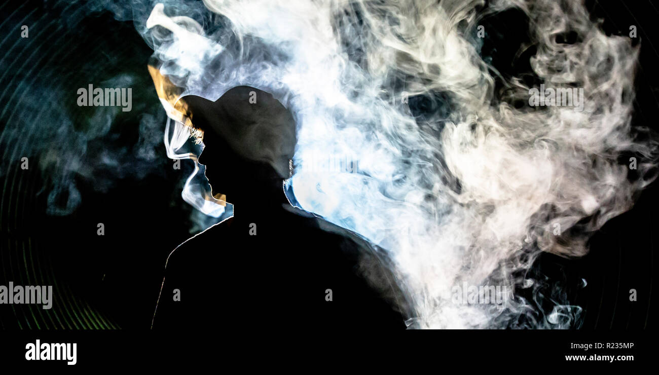 Silhouette of man and white smoke inside a tunnel Stock Photo - Alamy