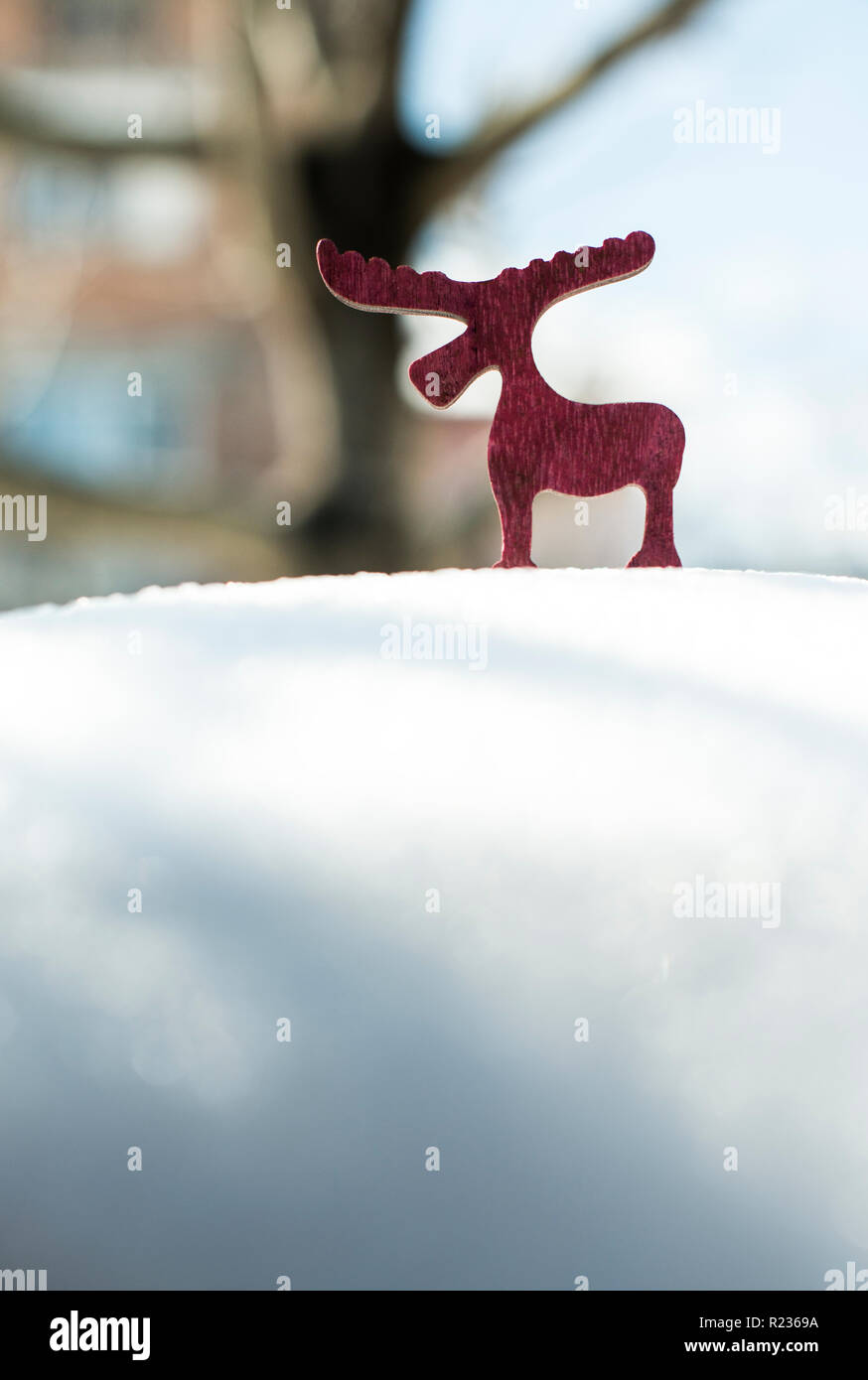 Wooden Christmas deer shape on snow Stock Photo - Alamy