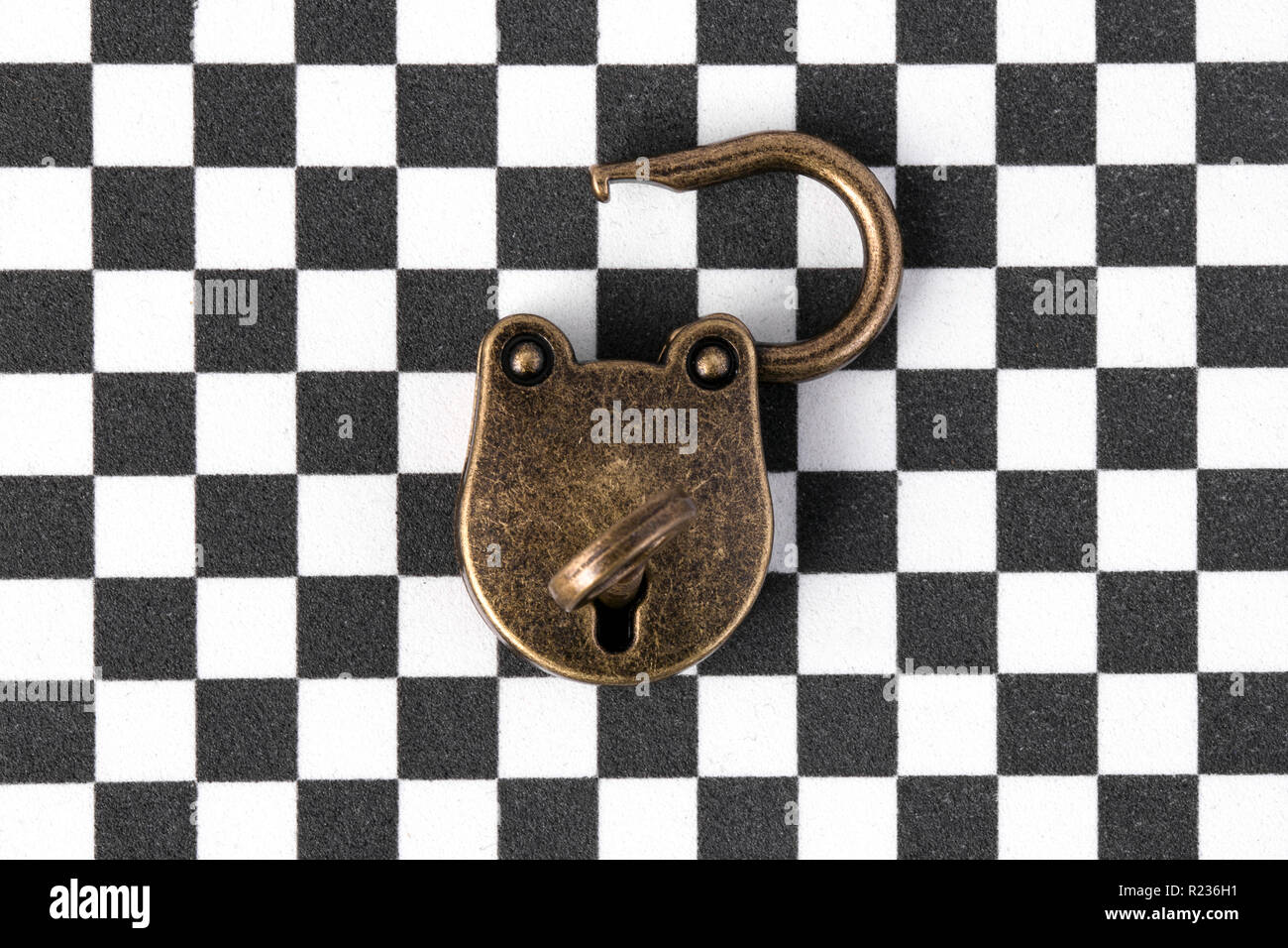 open bronze key lock on a checkerboard surface, background image Stock ...