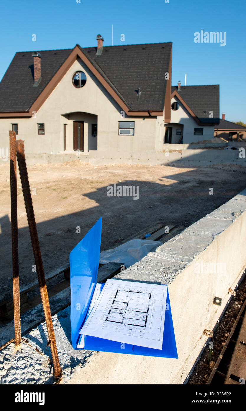 New build house and blueprints. Construction site Stock Photo - Alamy