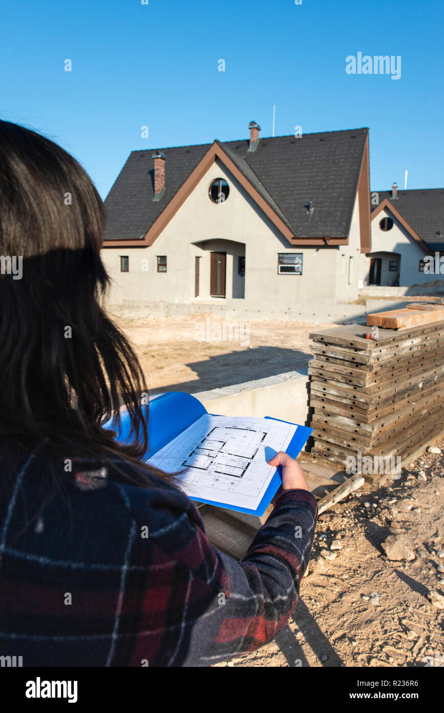 New build house and blueprints. Construction site Stock Photo - Alamy