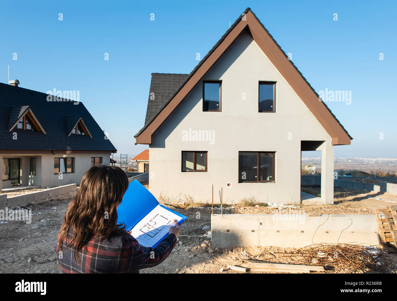 New build house and blueprints. Construction site Stock Photo - Alamy