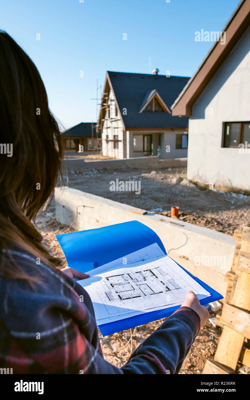 New build house and blueprints. Construction site Stock Photo - Alamy