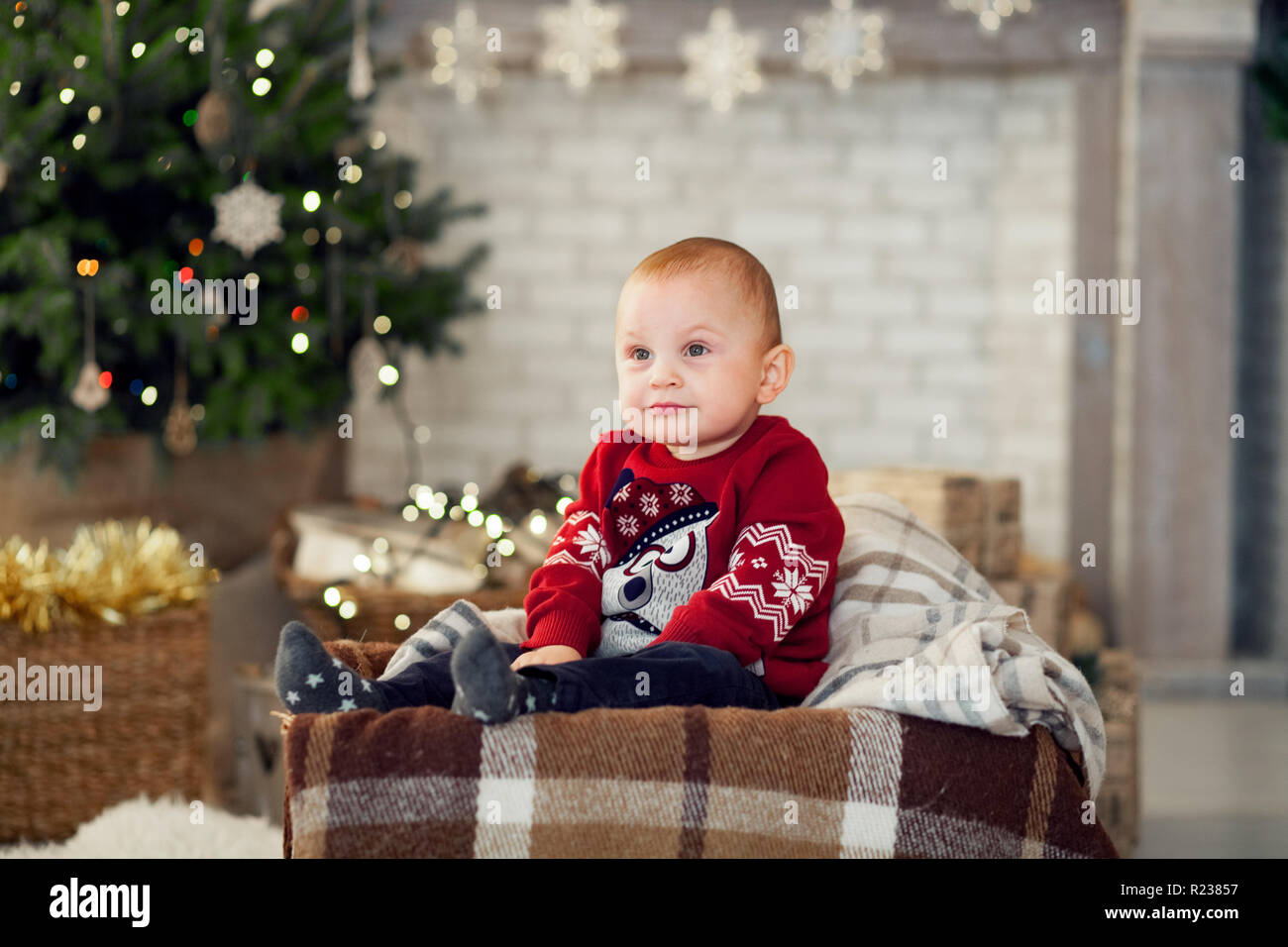 Boy sitting against tree hi-res stock photography and images - Alamy