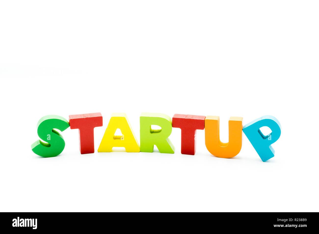 Word STARTUP written with colourful wooden letters, isolated over white ...