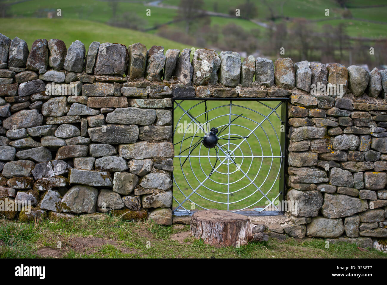 An art installation of a mock spider web with a spider set within a dry ...
