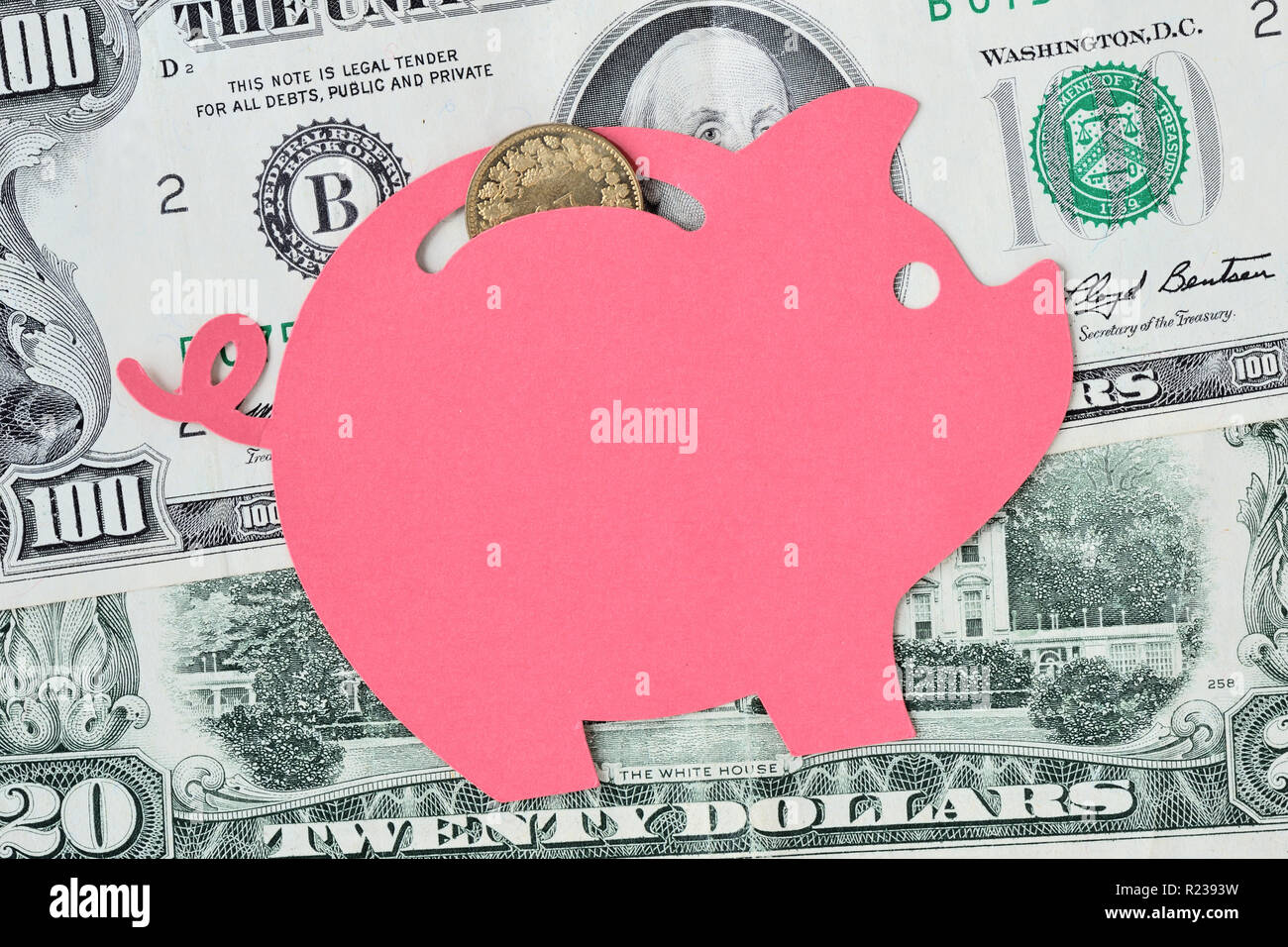 Piggy bank on dollar banknotes and coins - Saving money concept Stock ...