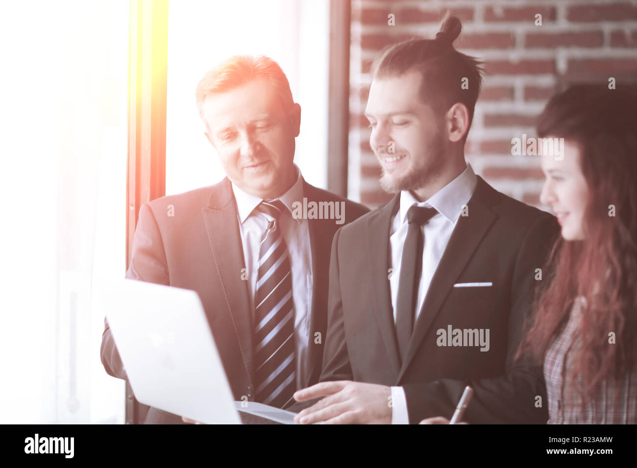 closeup.the boss and employees look at the laptop screen Stock Photo ...