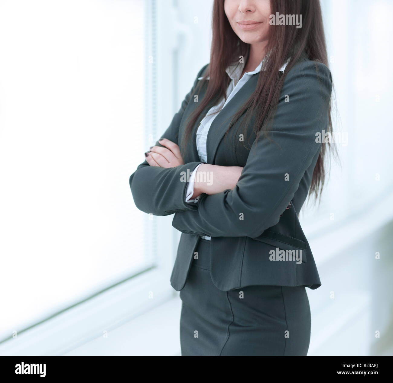 Executive business woman standing near window in spacious office Stock ...