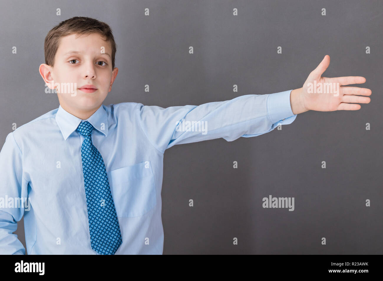 The boy standing near the blackboard, emotionally demonstrates ...